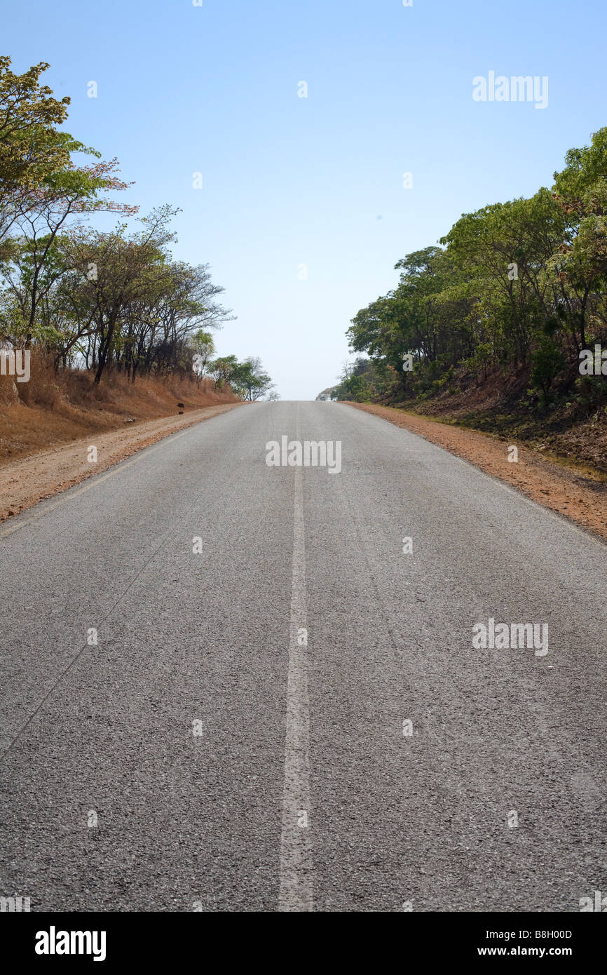 Road leading up a hill with blue sky Stock Photo - Alamy