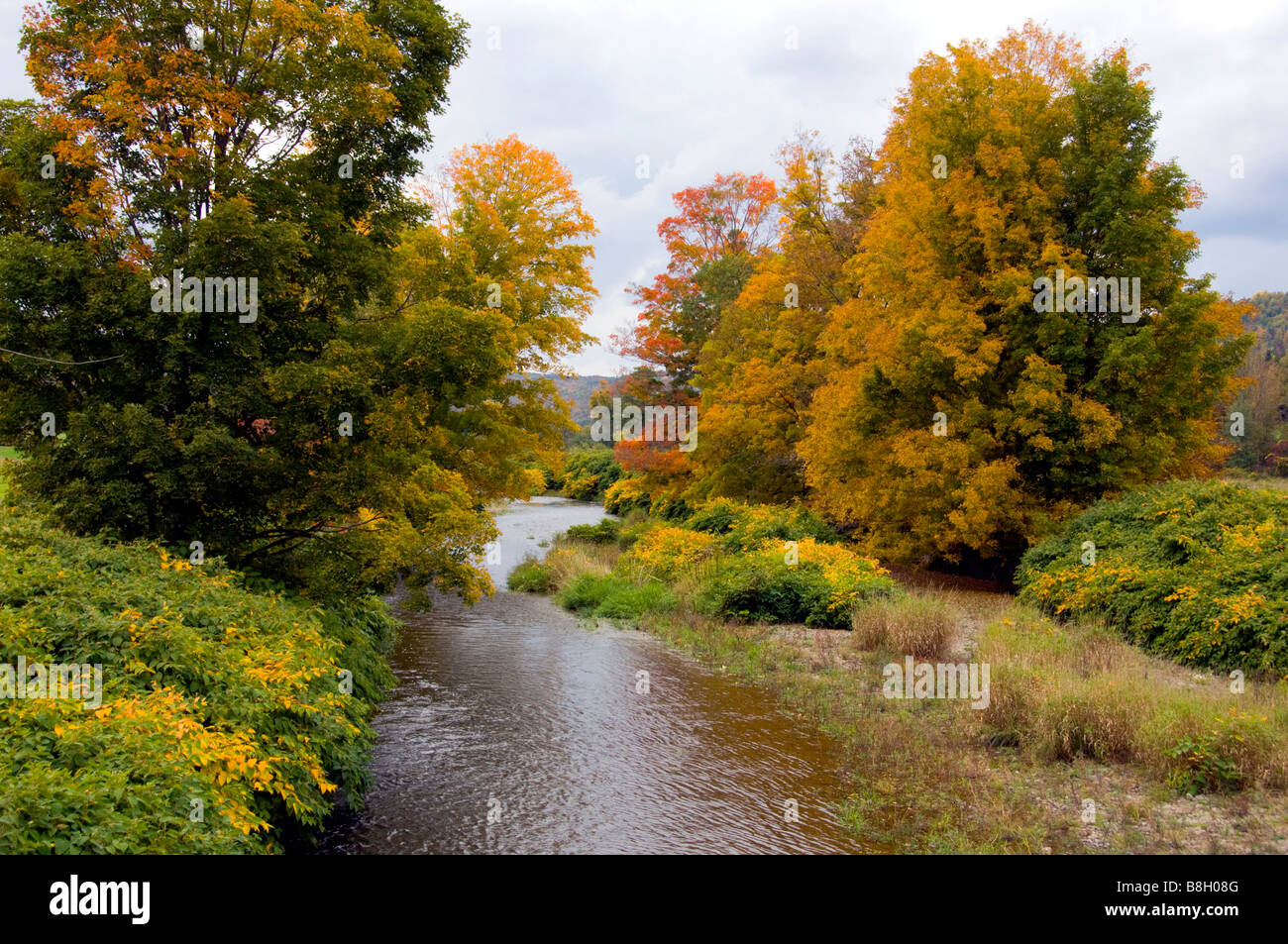 A small river in the Catskills of New York state with fall foliage ...