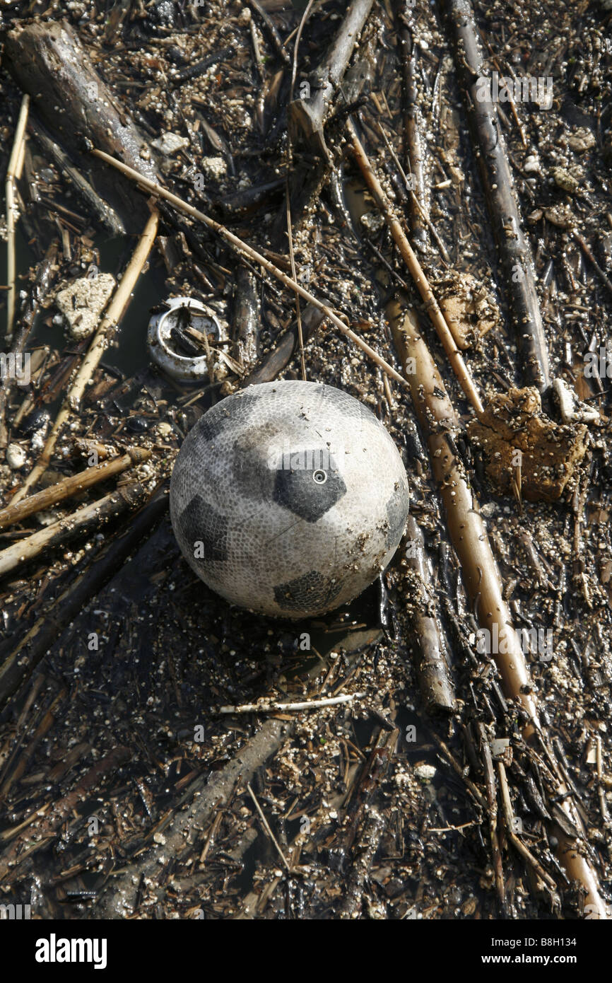 lots of rubbish garbage and ball floating in river in sun Stock Photo ...