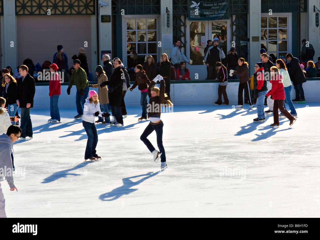 Ice Skaters skating on rink Stock Photo - Alamy