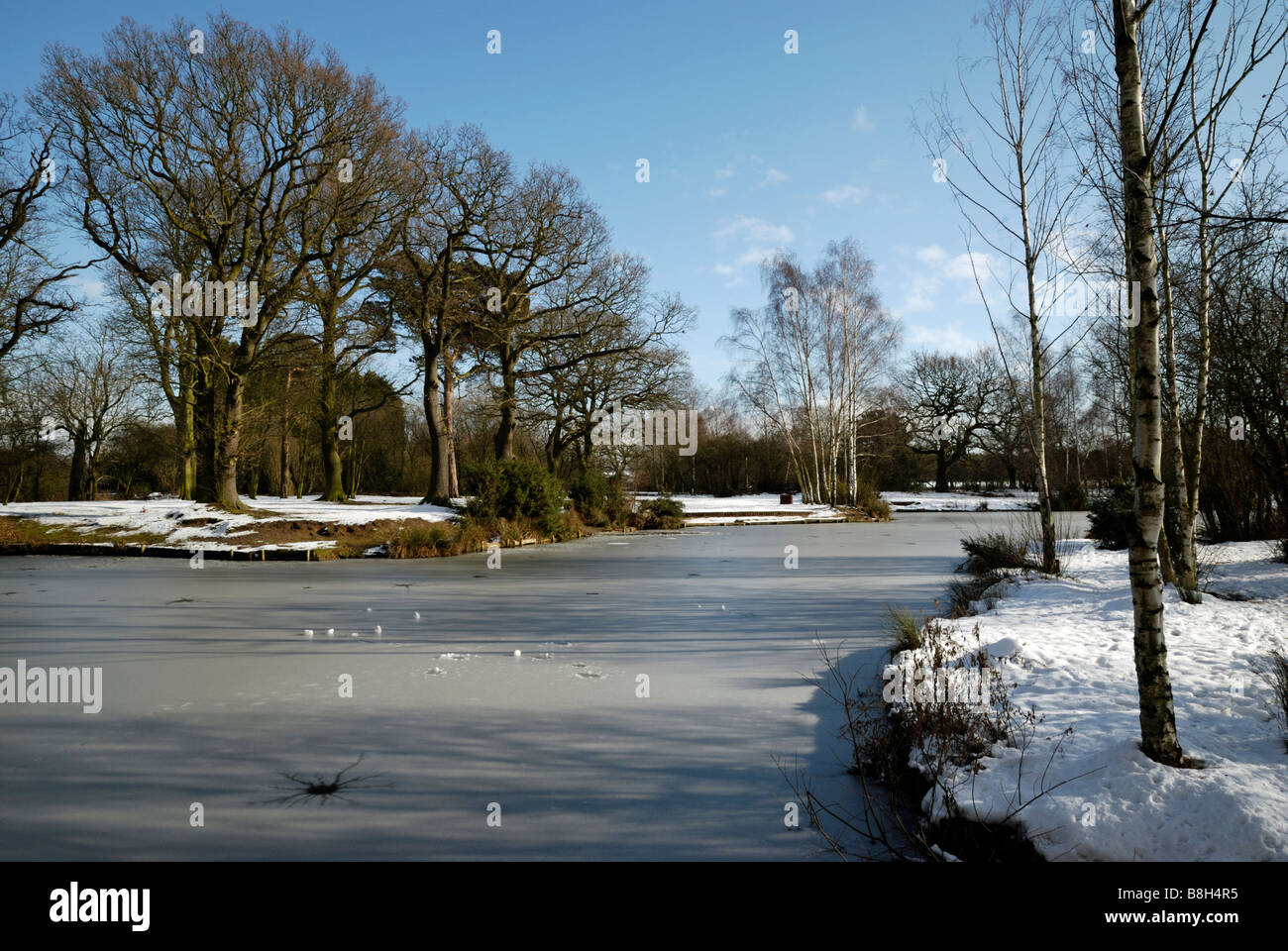 A frozen lake with snowy banks. Ancaster, Lincolnshire, England Stock ...