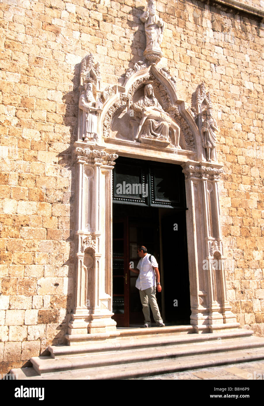 medieval church with steps to doorway with biblical reliefs Stock Photo ...