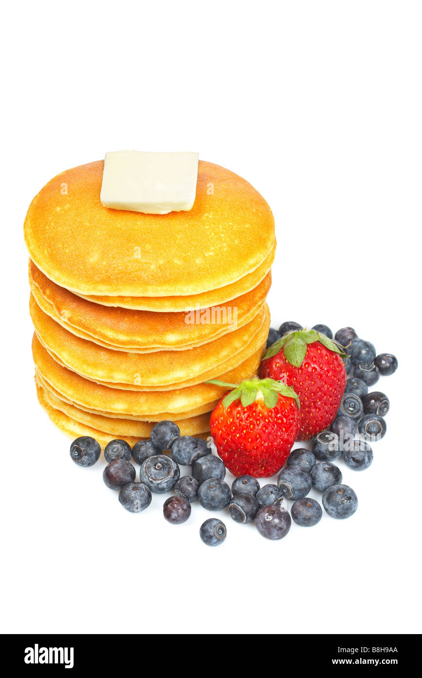 A big stack of pancakes with butter blueberries and strawberries on ...
