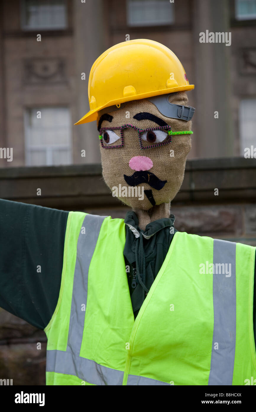 Straw road workmen with straw hessian heads, yellow hard hats. Hi-Vis ...