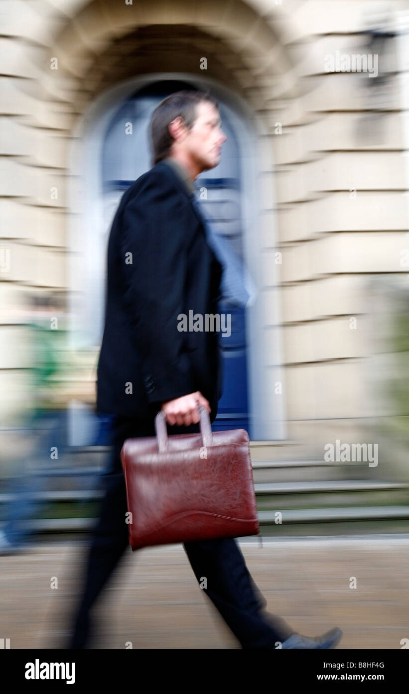 Businessman carrying a briefcase in financial district Stock Photo - Alamy