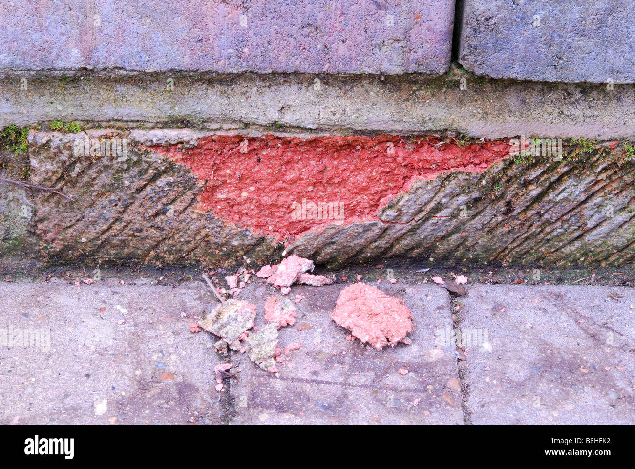 Effects of frost shattering on moss-covered house brick Stock Photo - Alamy