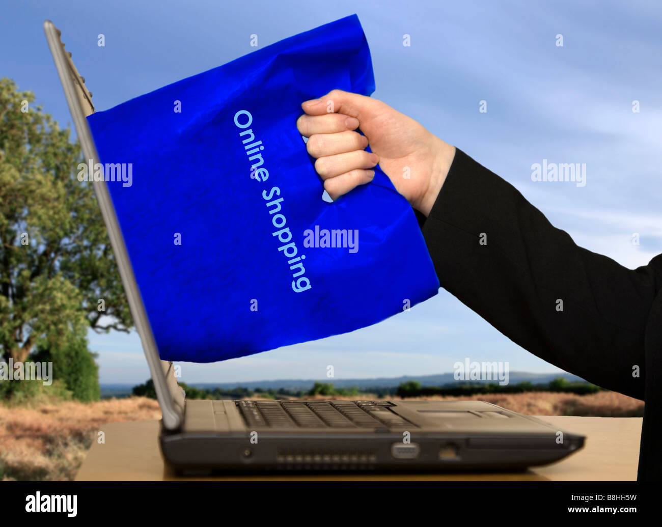 A person pulling a shopping bag out of a computer screen Stock Photo ...