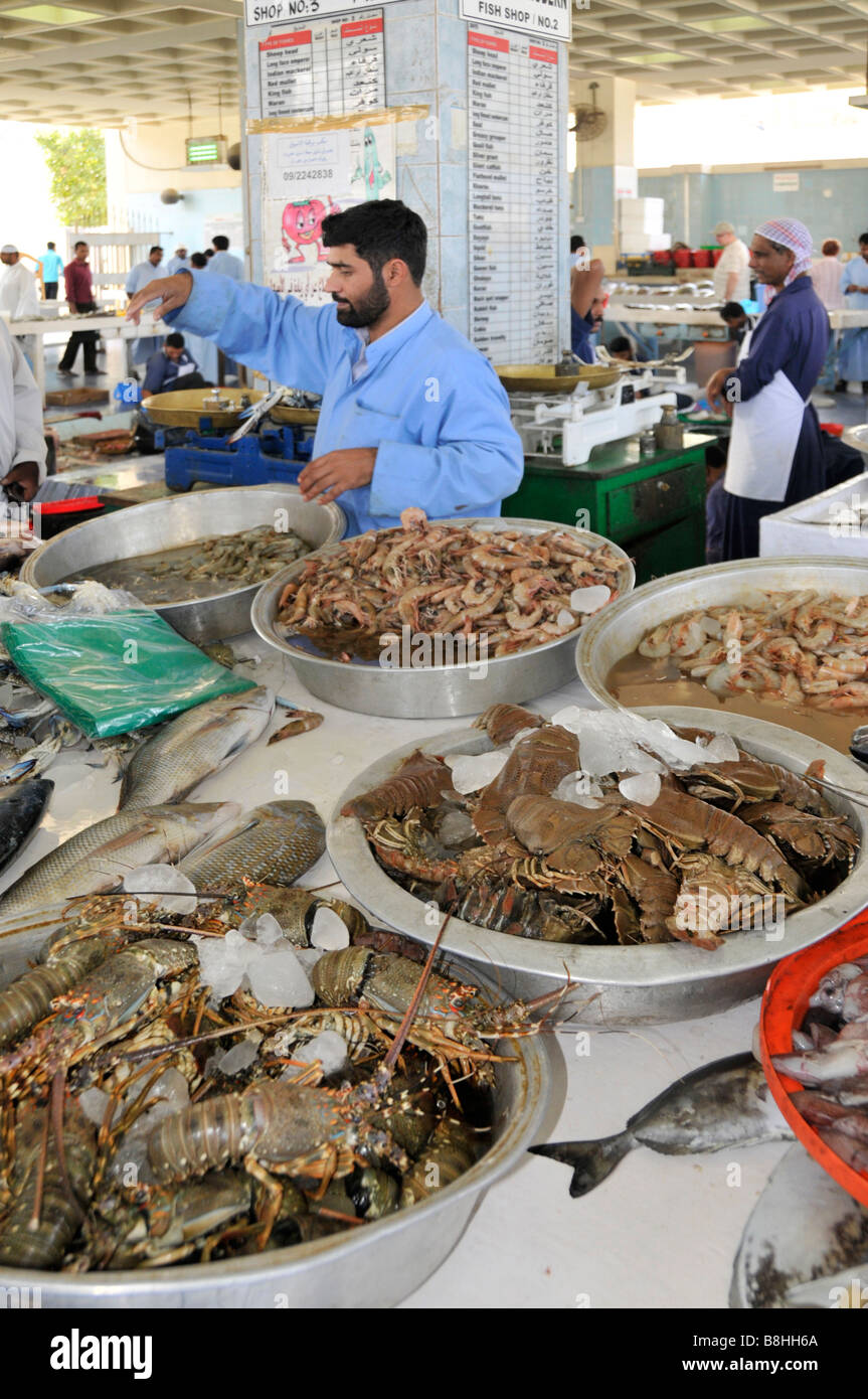 Fish displays and fishmonger vendors at work in Fujairah fish market ...
