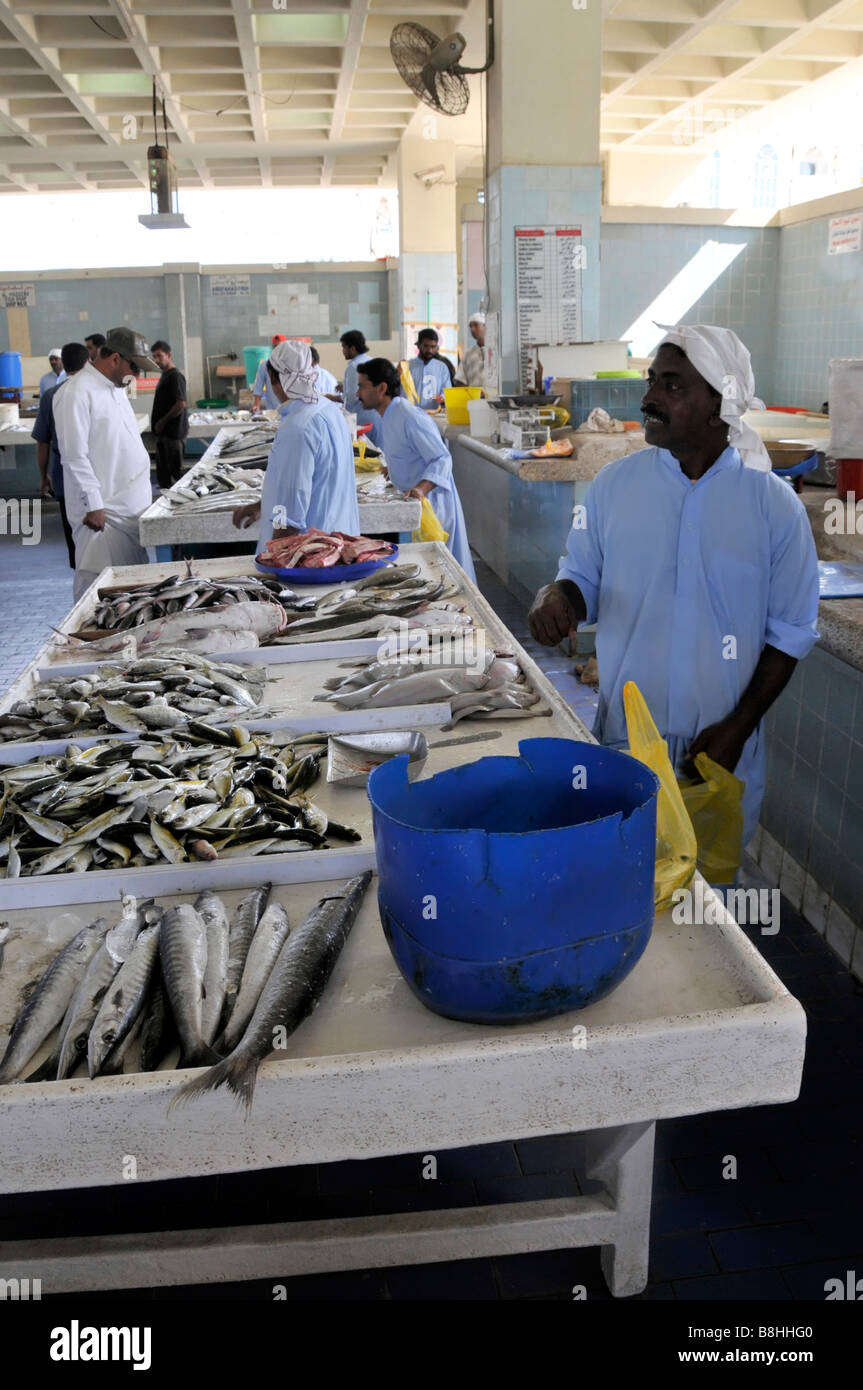 Fish displays and fishmonger vendors at work in Fujairah fish market ...