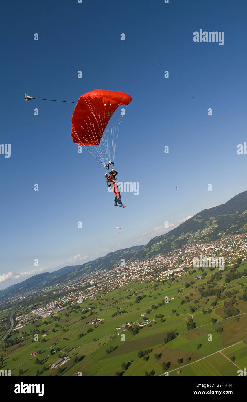 Skydive under canopy is flying along the green fields torts the ...