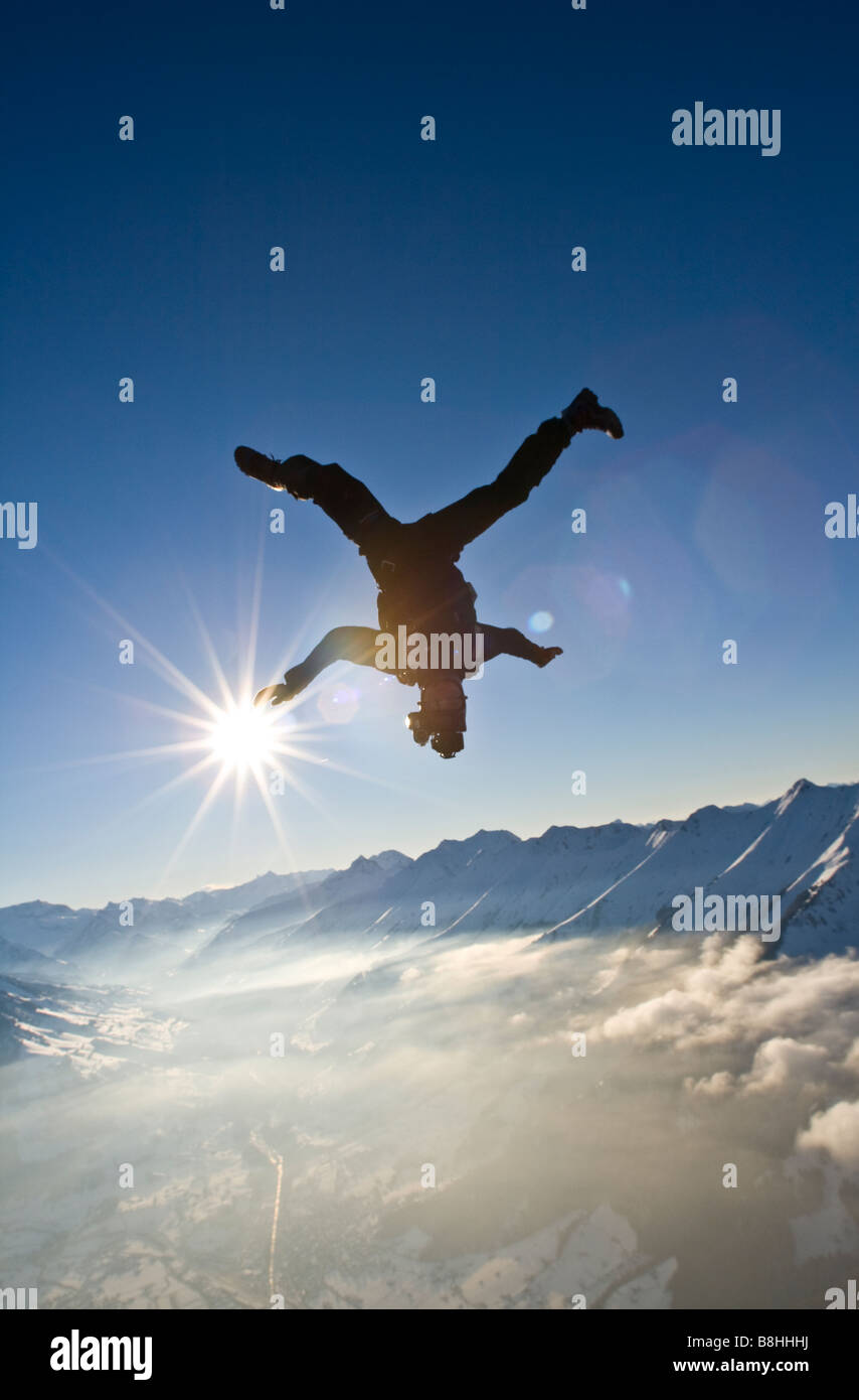 Skydiver is head down flying in the sky over the beautiful mountain ...