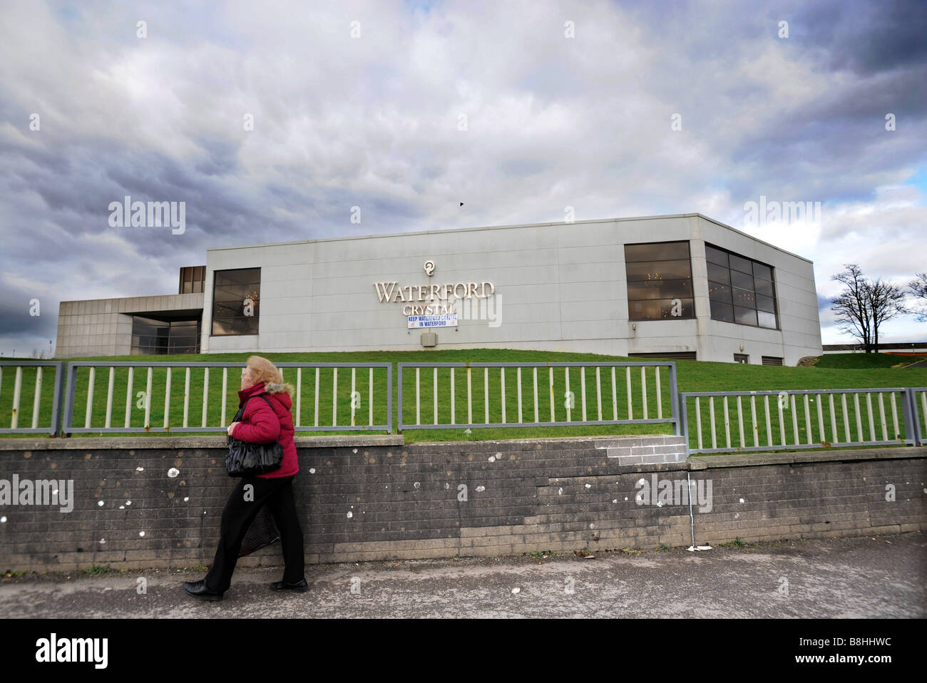 A woman walks past the Waterford crystal factory in Waterford Ireland ...