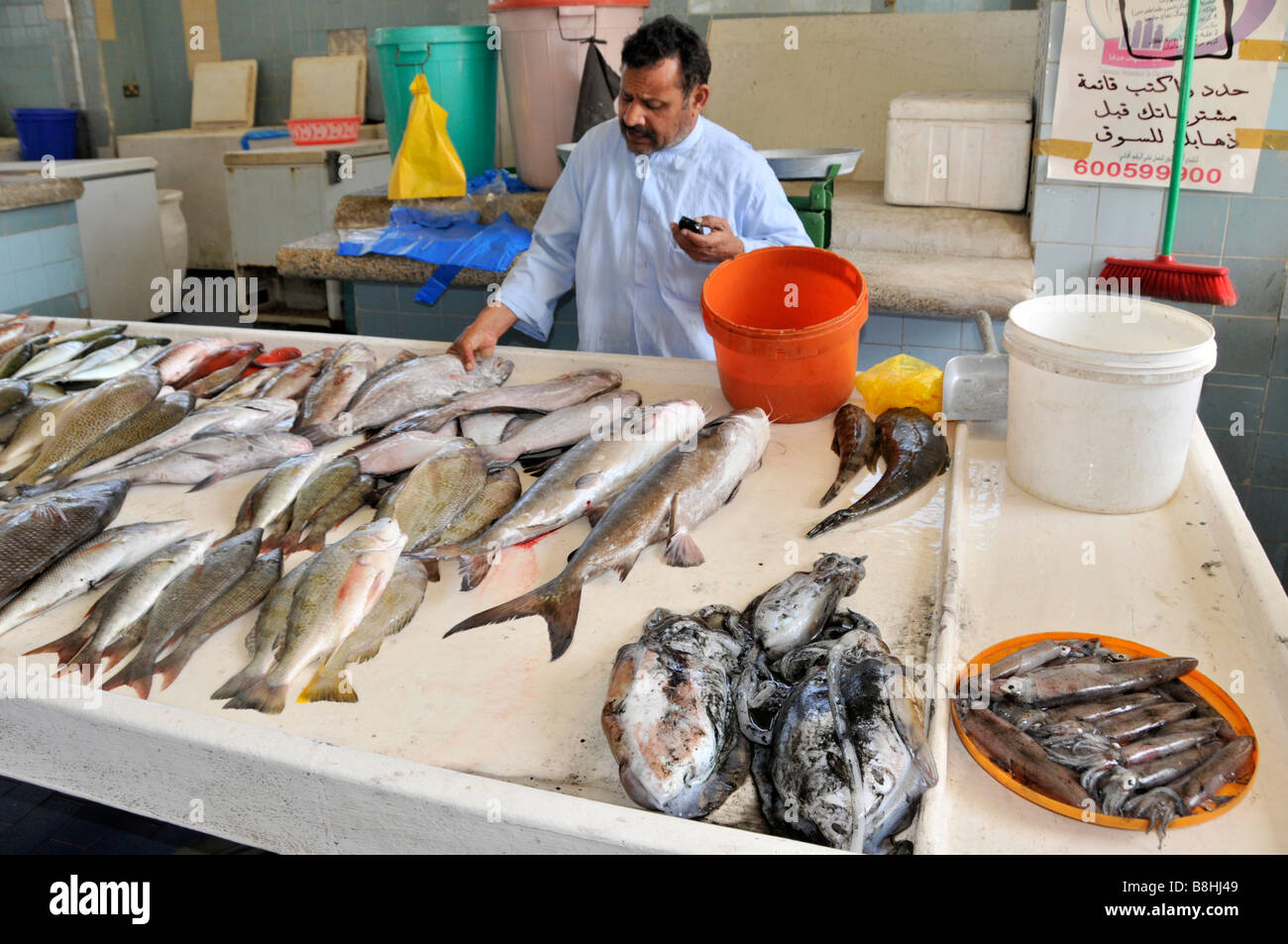 Fish display and fishmonger vendors at work in Fujairah fish market ...