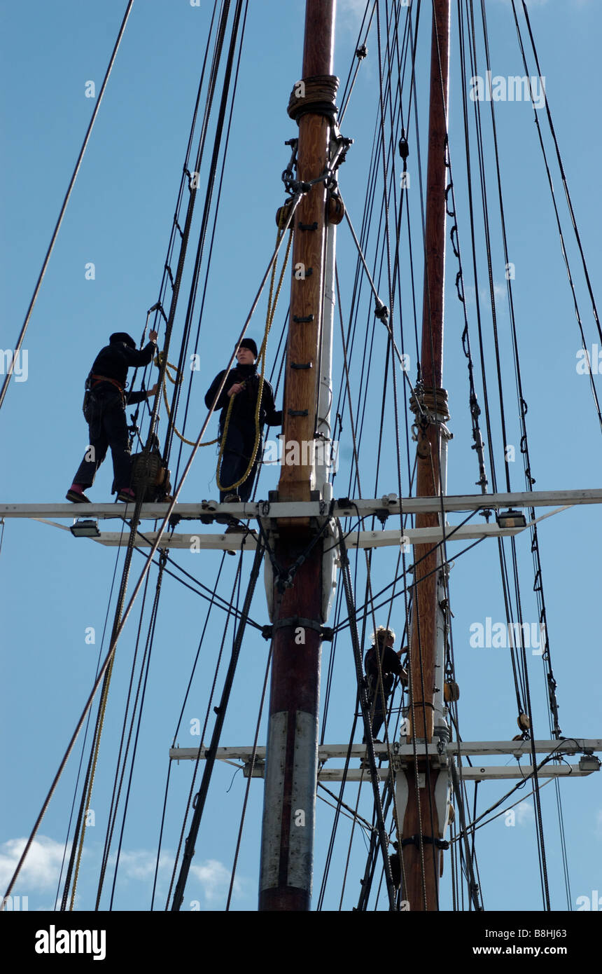 Two women working high in the rigging of a tall ship Stock Photo - Alamy