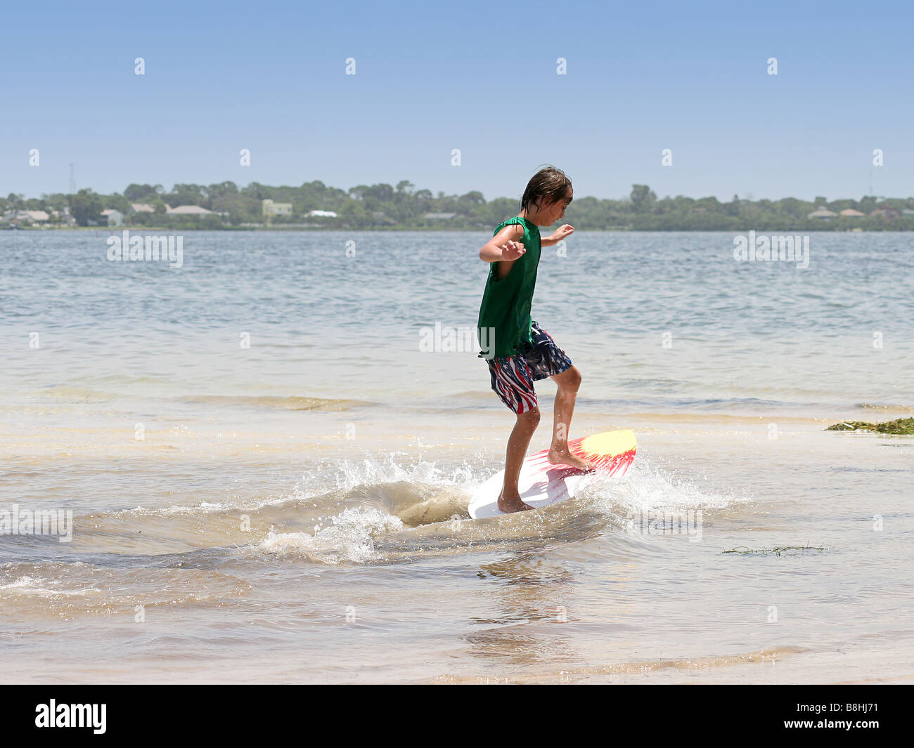boy skim boarding at the beach Stock Photo - Alamy