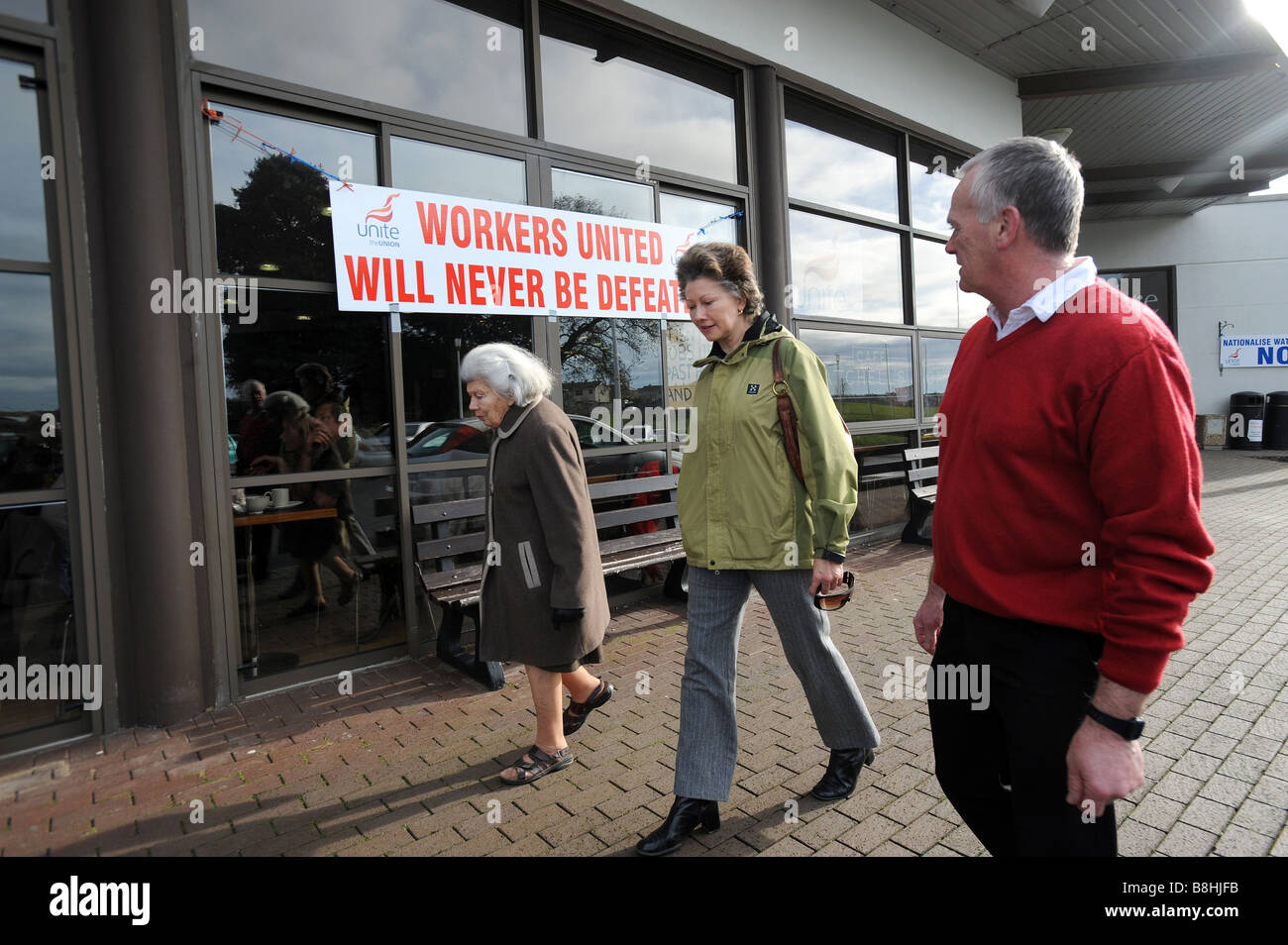 Waterford crystal protestor Ian Paul shows visitors Monica and ...