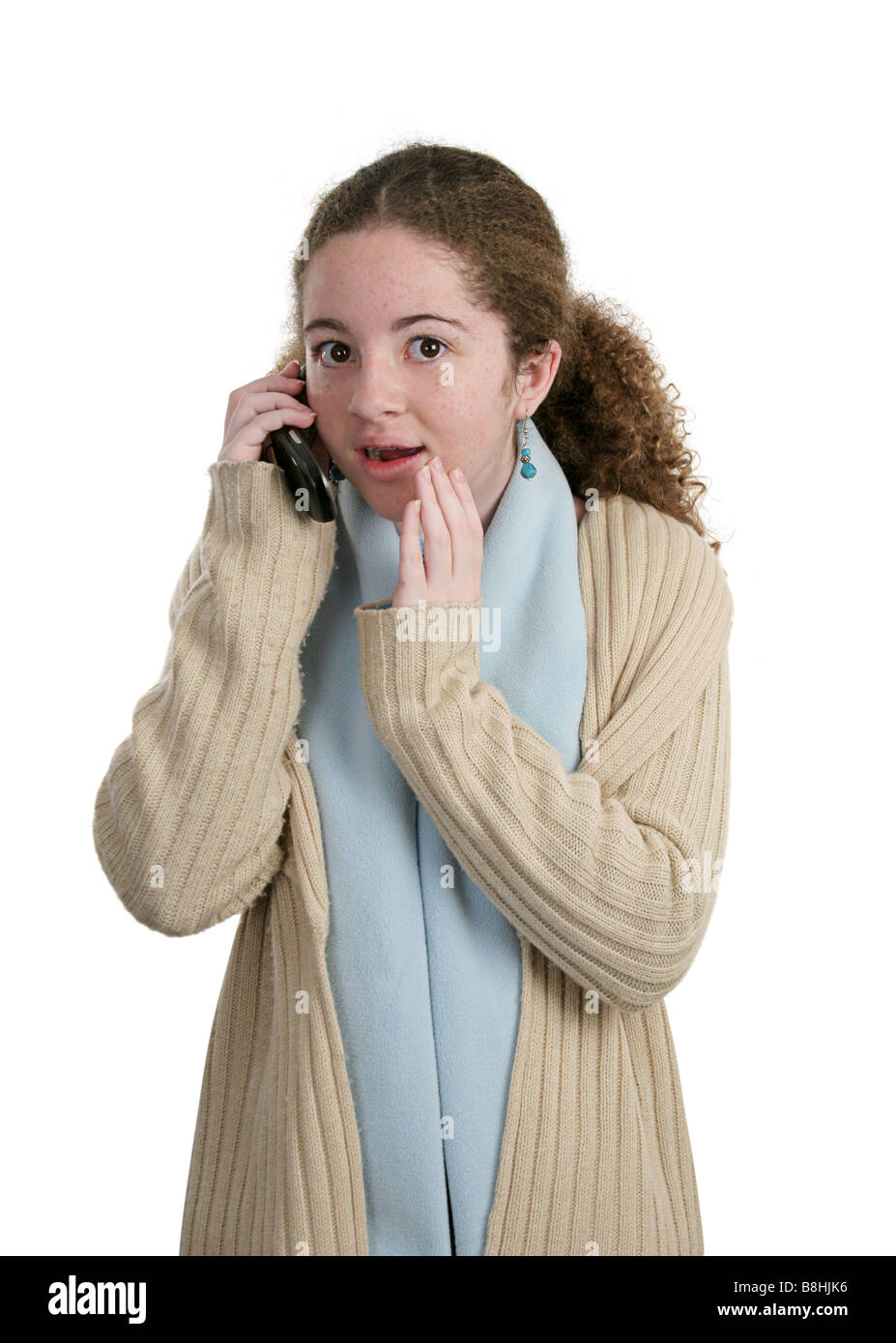 A cute teen girl sharing juicy gossip over the phone Isolated Stock ...