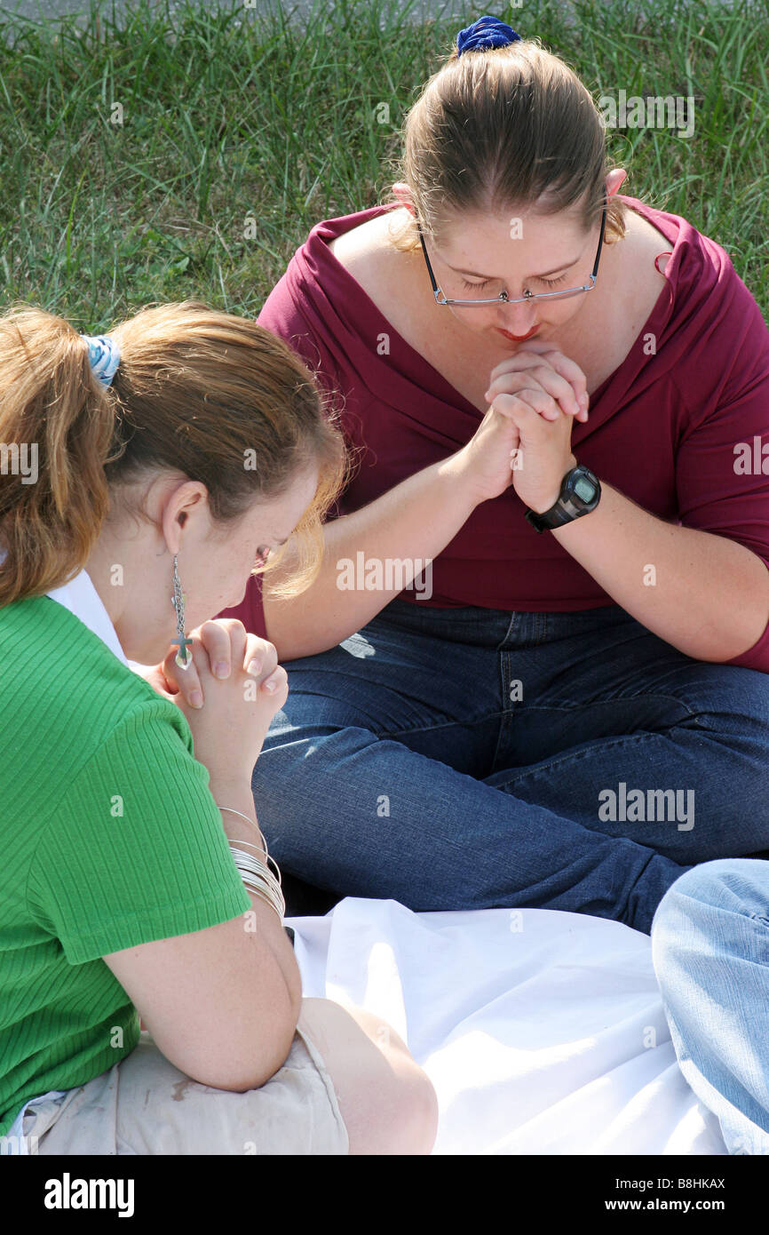 A closeup of two teen girls in prayer Stock Photo - Alamy