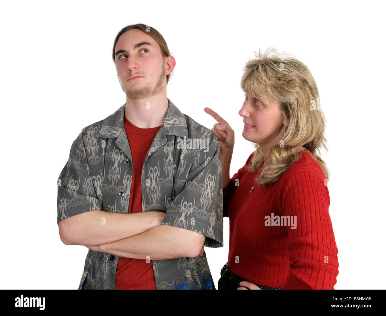 A teen boy ignoring his mother rolling his eyes while she lectures him ...