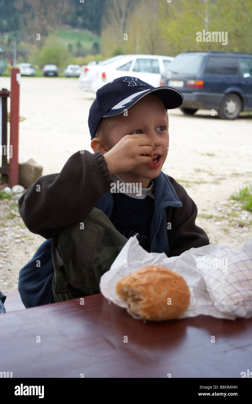 child eating a sandwich in wayside bar Stock Photo - Alamy
