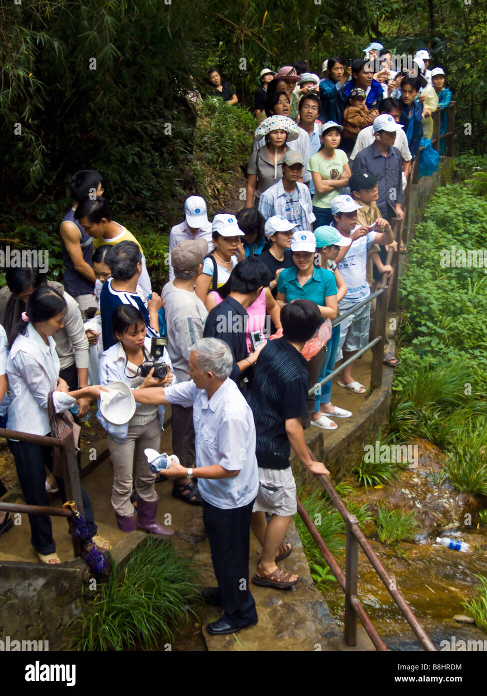 Crowds of tourists gathered on pathway by Silver Waterfall Sapa Vietnam ...