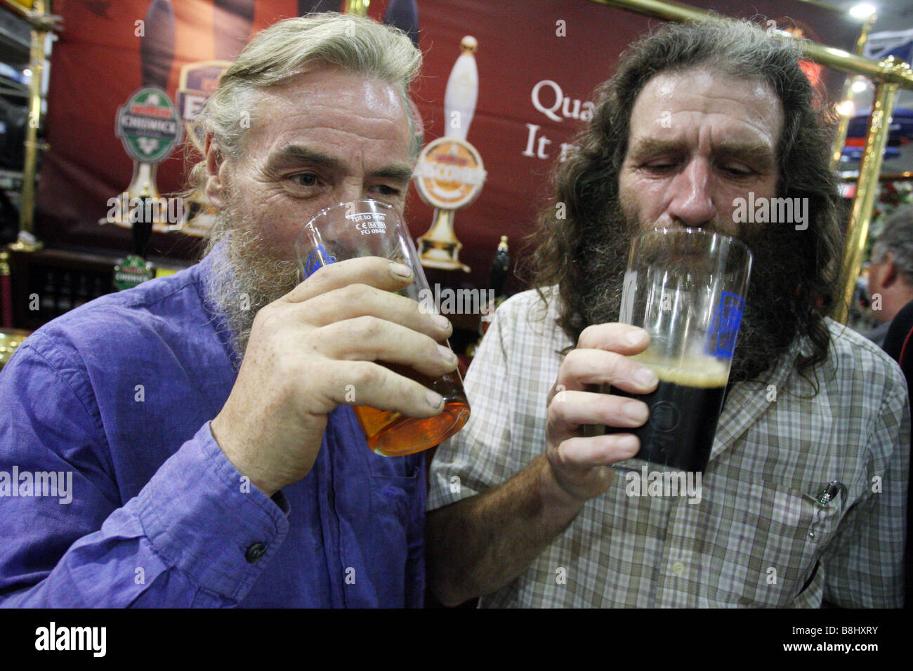 Two men with beards drink beer at The Great British Beer Festival, Earl ...