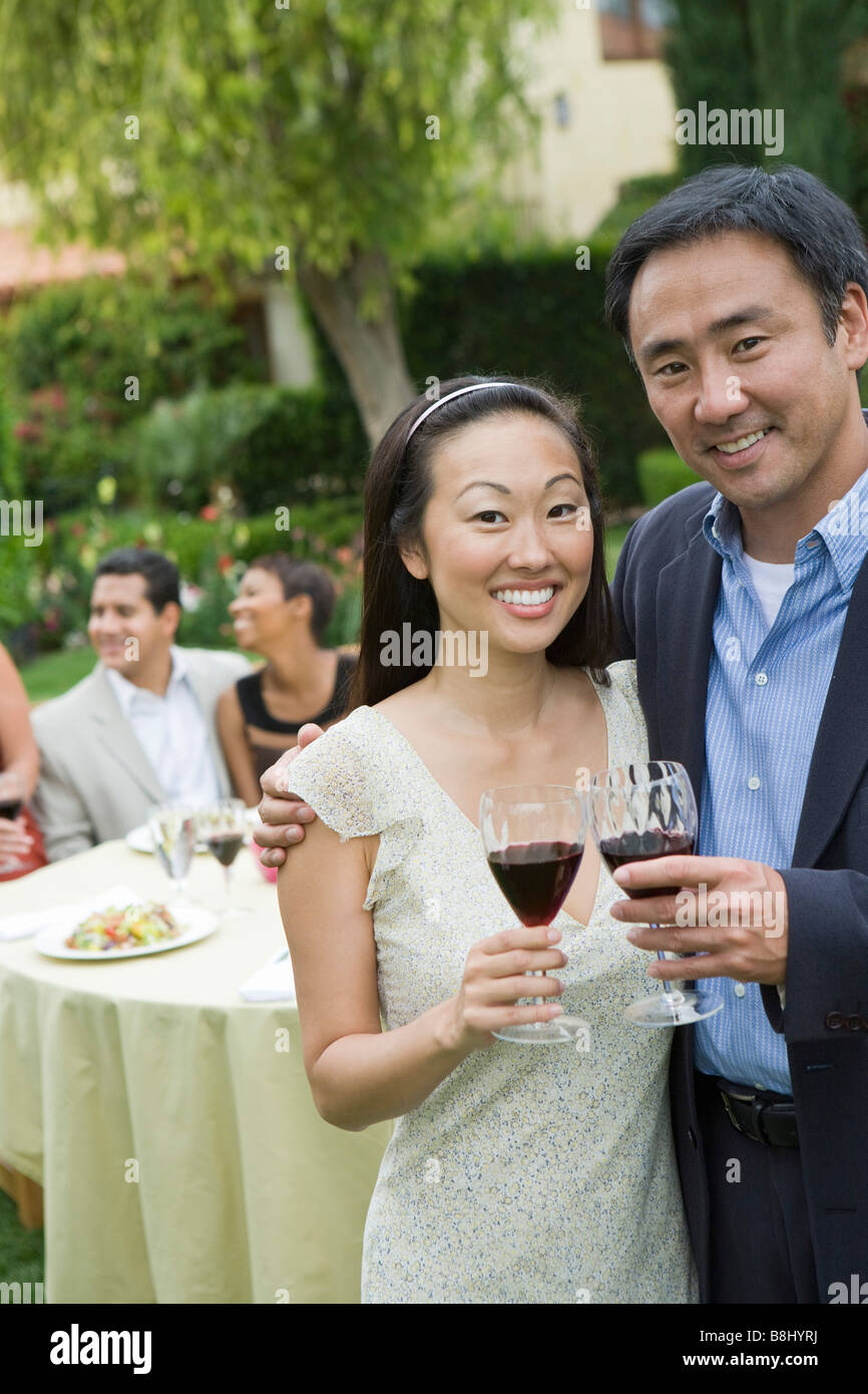 Couple drinking wine with friends outdoors Stock Photo - Alamy