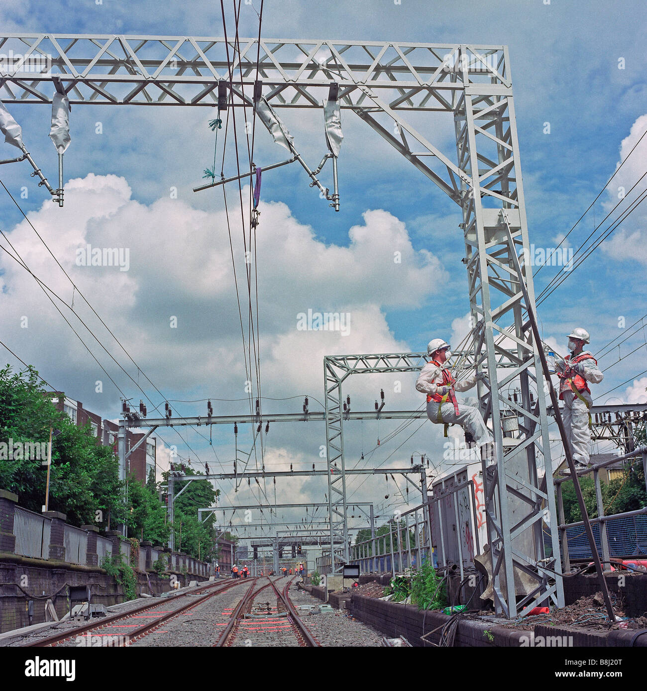 Contractors repainting support gantry for an overhead caternary power ...