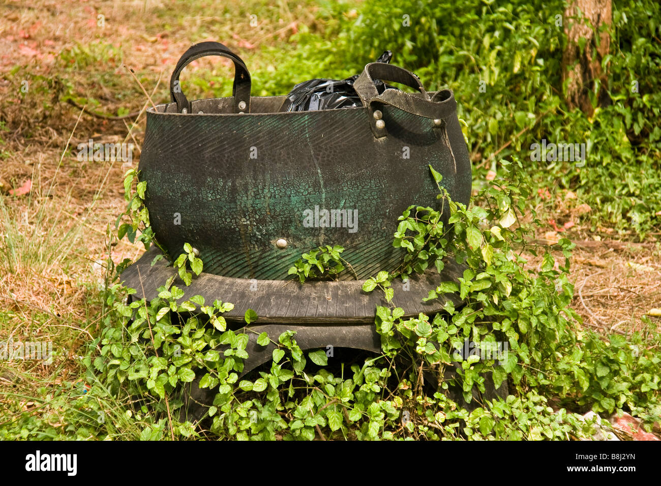A typical Thai roadside dustbin, converted from a tyre Stock Photo - Alamy