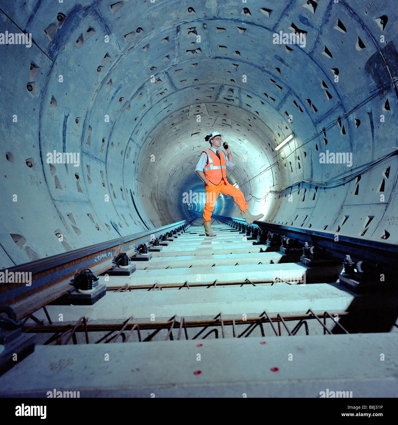 Engineer inspecting newly laid trackwork in a Jubilee Line Extension ...