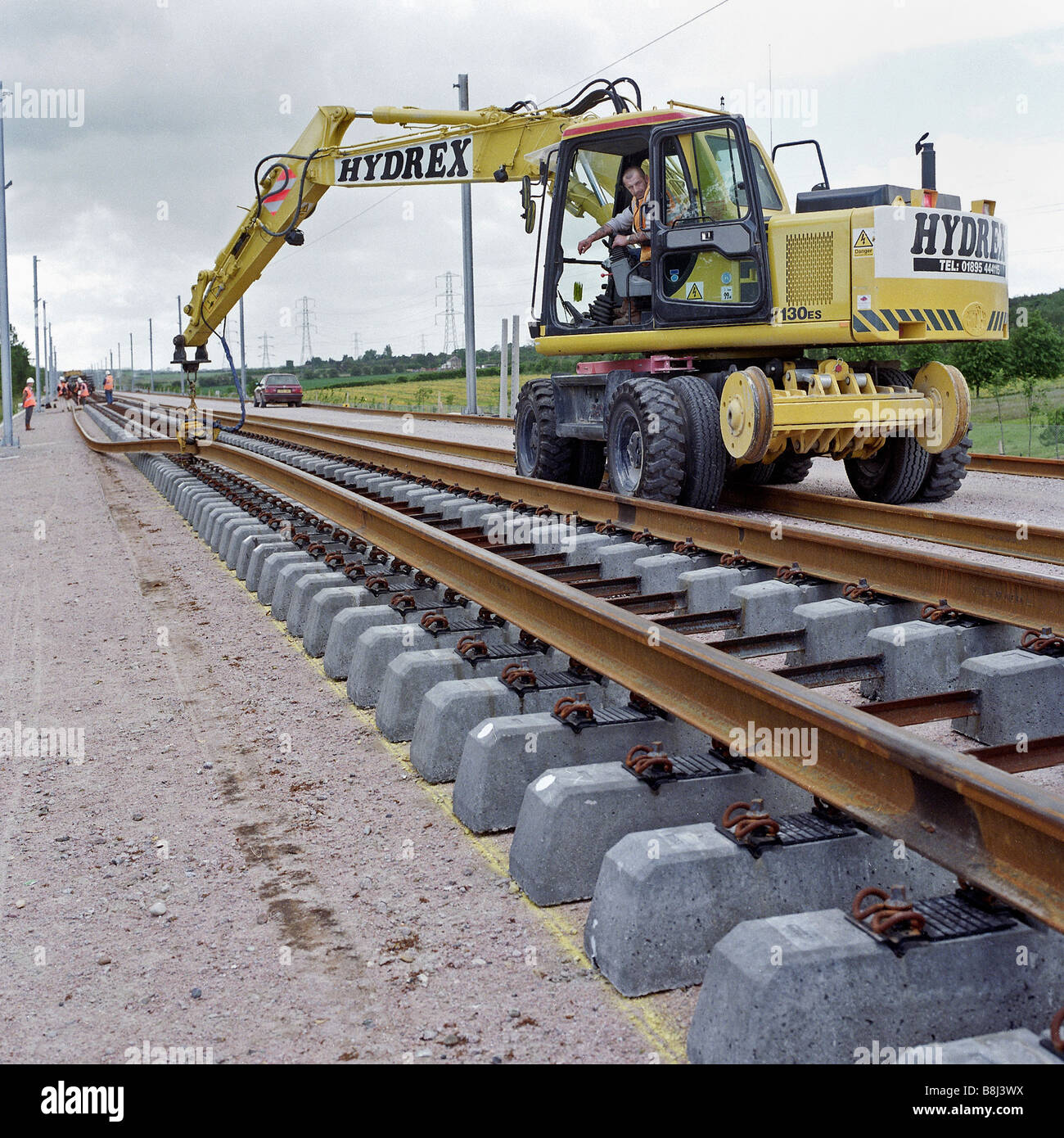 Contractor using road-rail machine to lift long lengths of welded rail ...