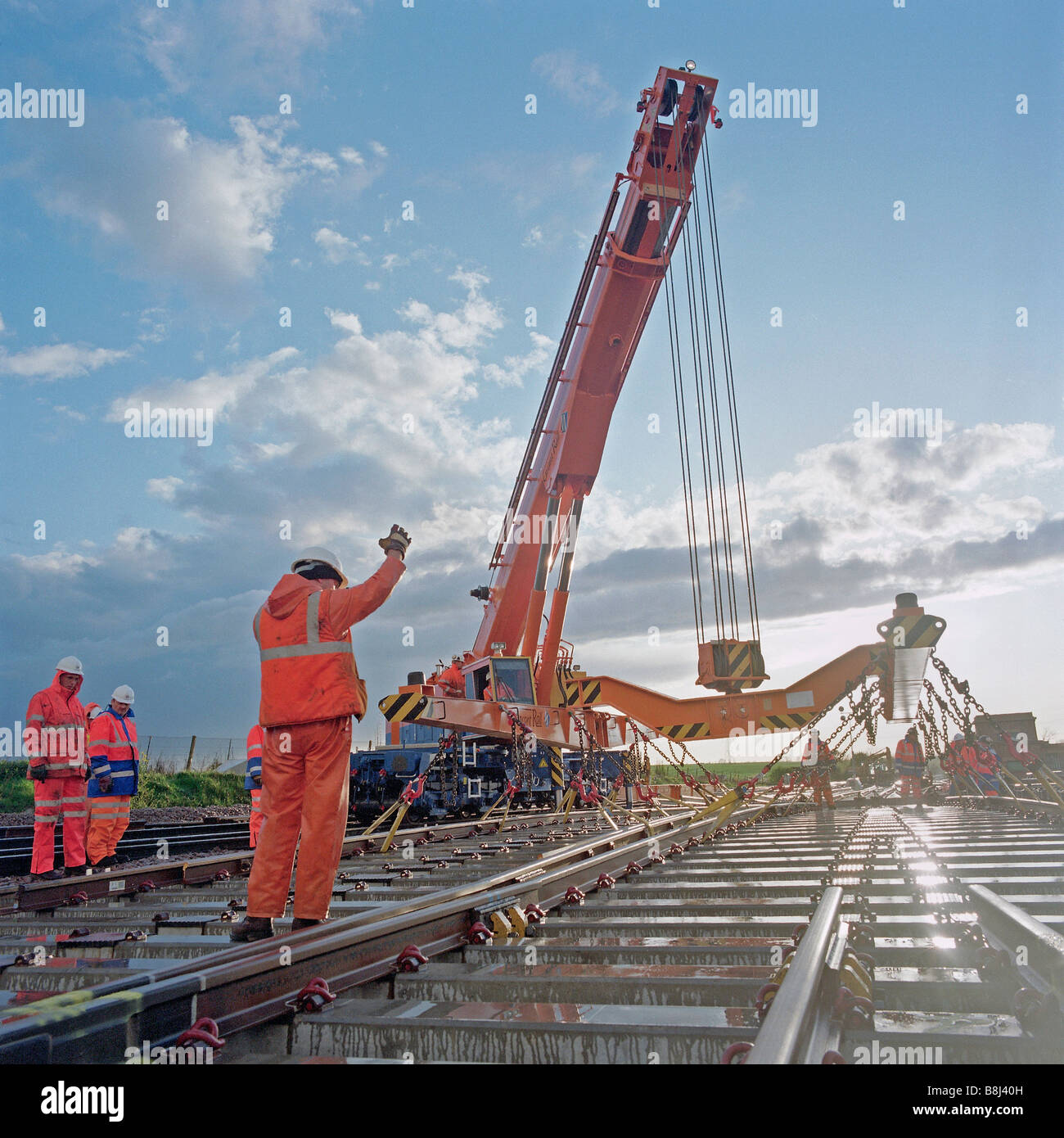 Contractors using huge Kirow crane lower prefabricated rail to create ...