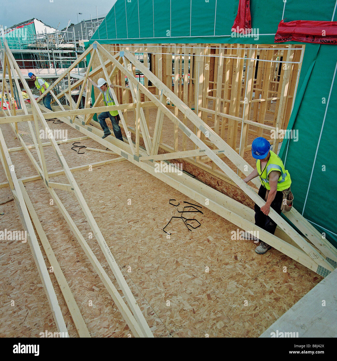 Contractors assembling a timber-framed structure - a fast, economical ...