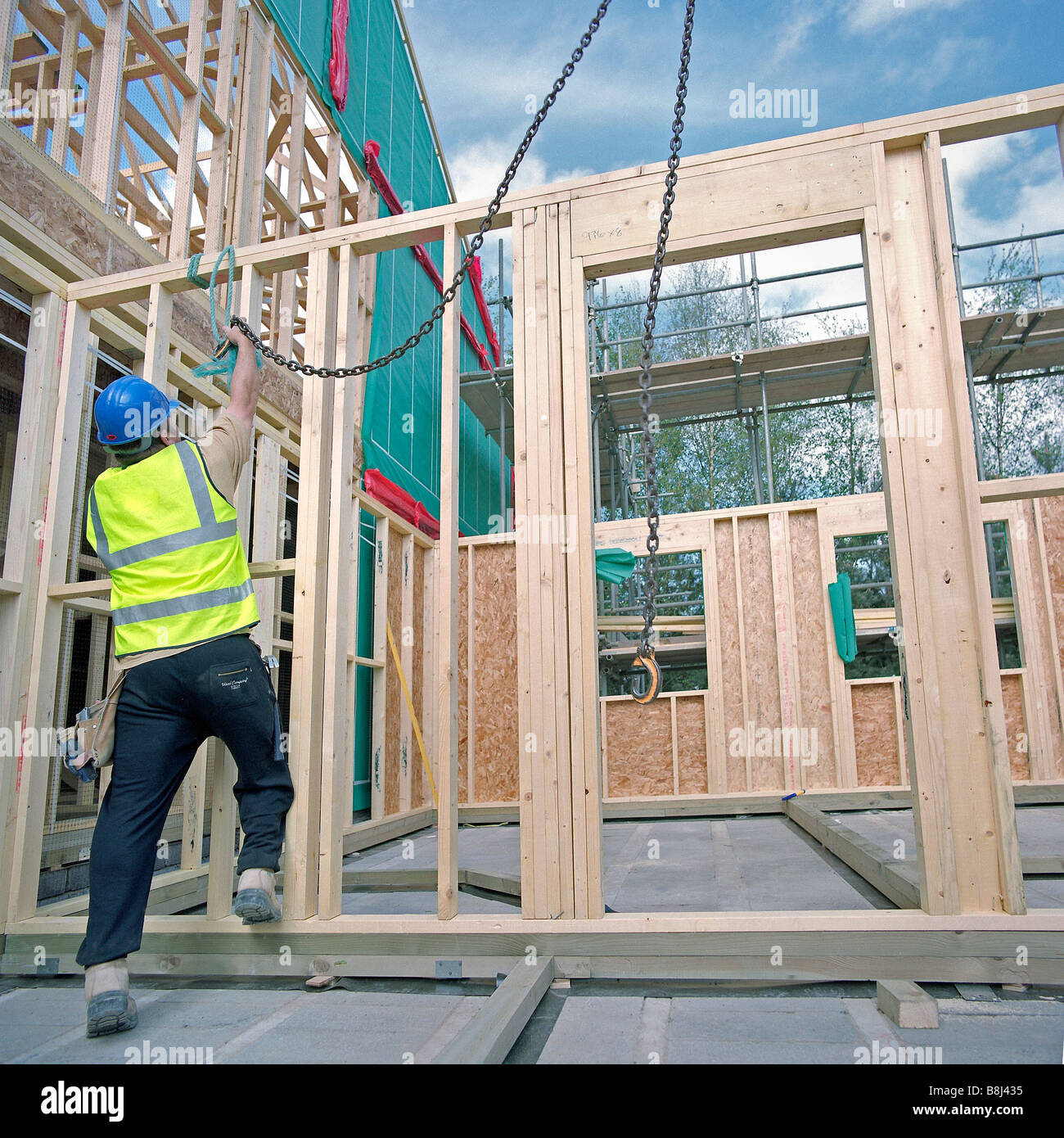 Contractors assembling a timber-framed structure - a fast, economical ...