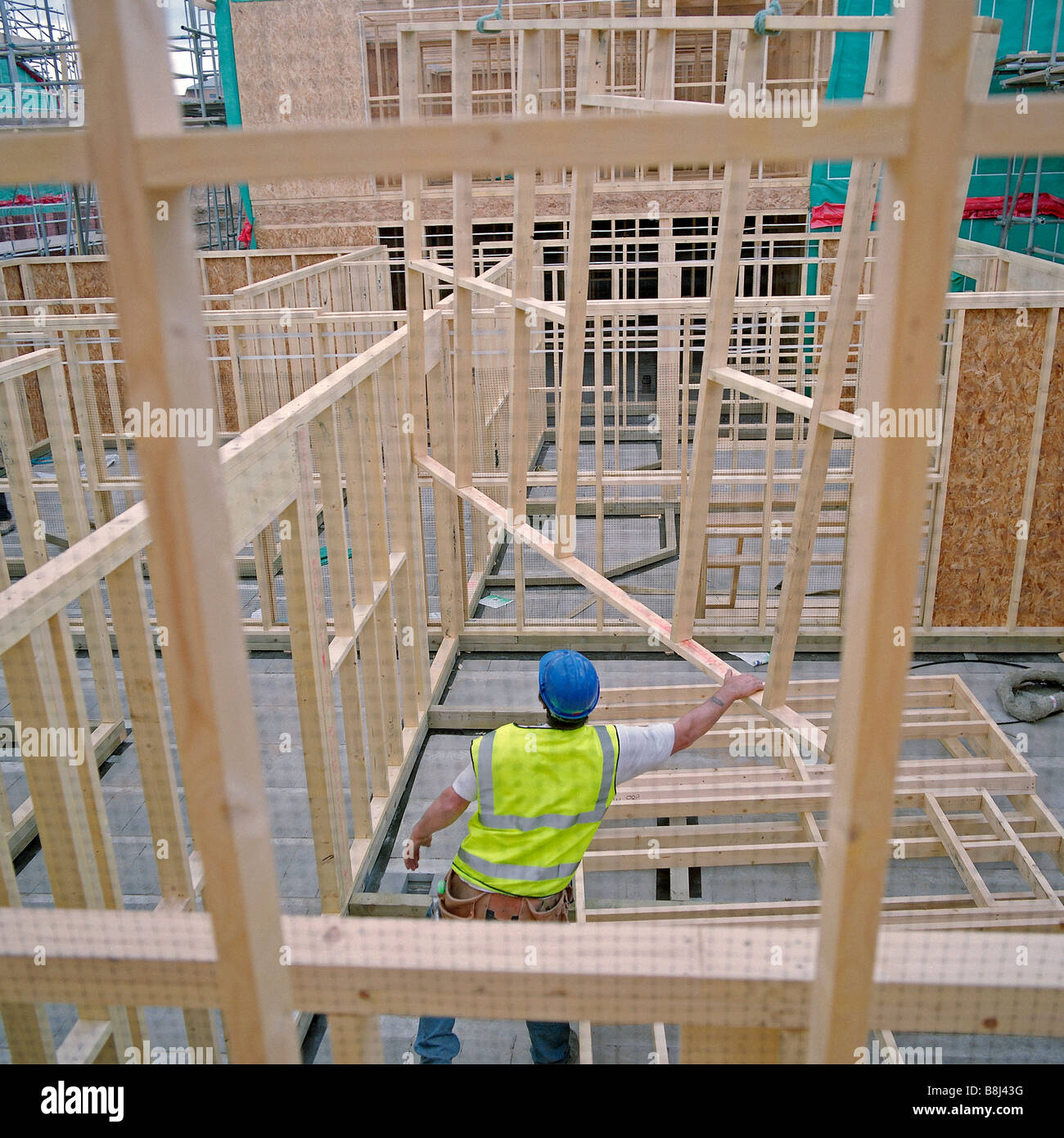 Contractors assembling a timber-framed structure - a fast, economical ...