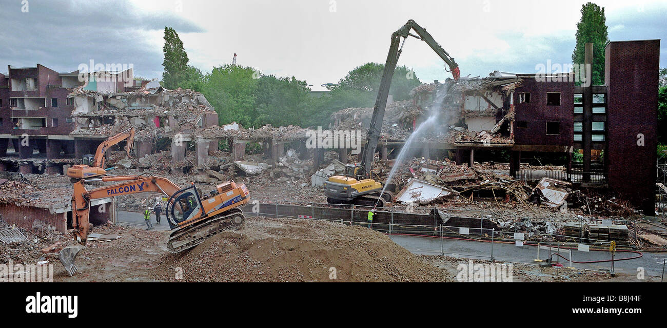 Machine-mounted breaker destroying reinforced concrete walls of ...