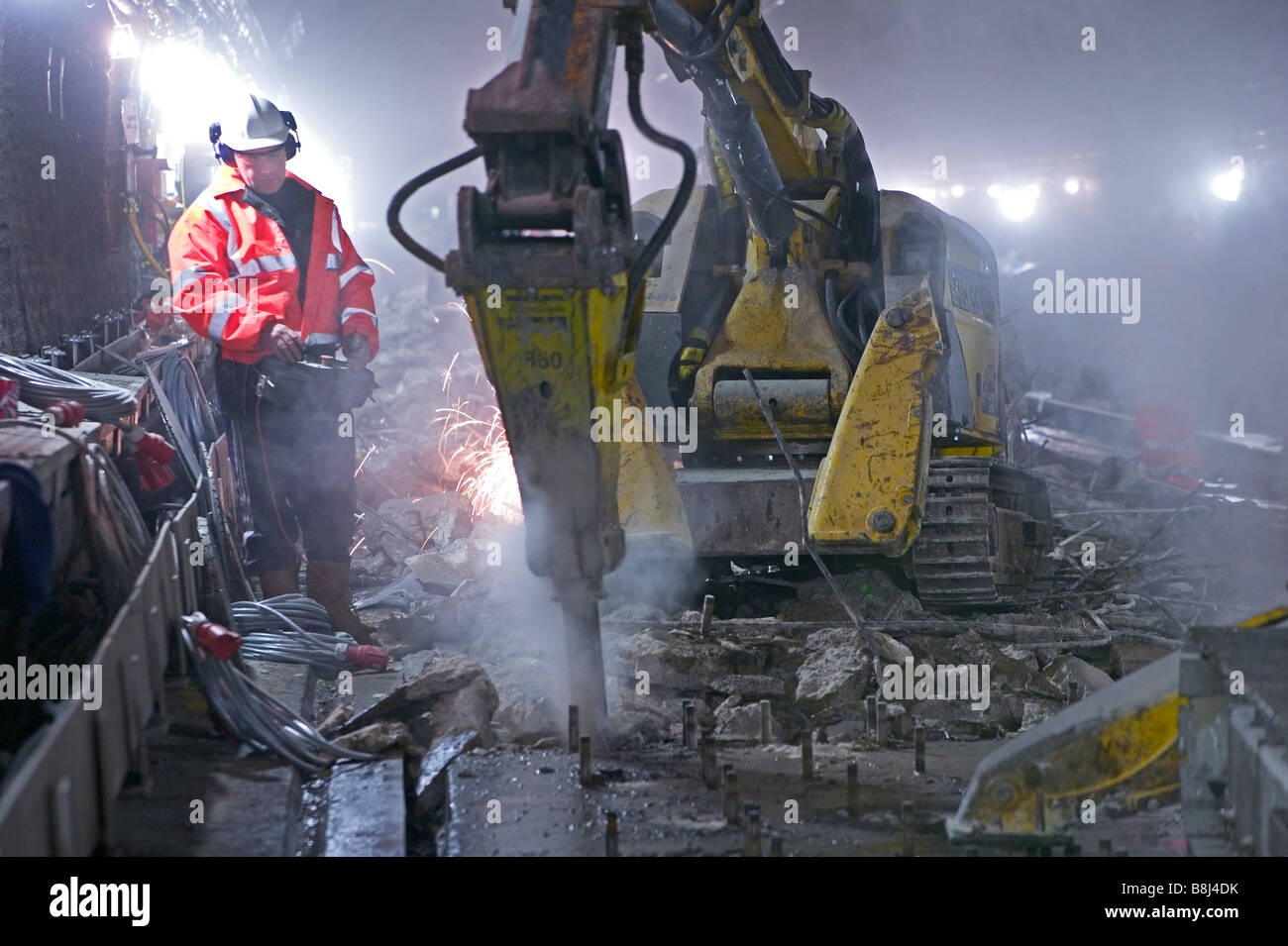 Operative using remote controlled concrete breaker excavating worn-out ...