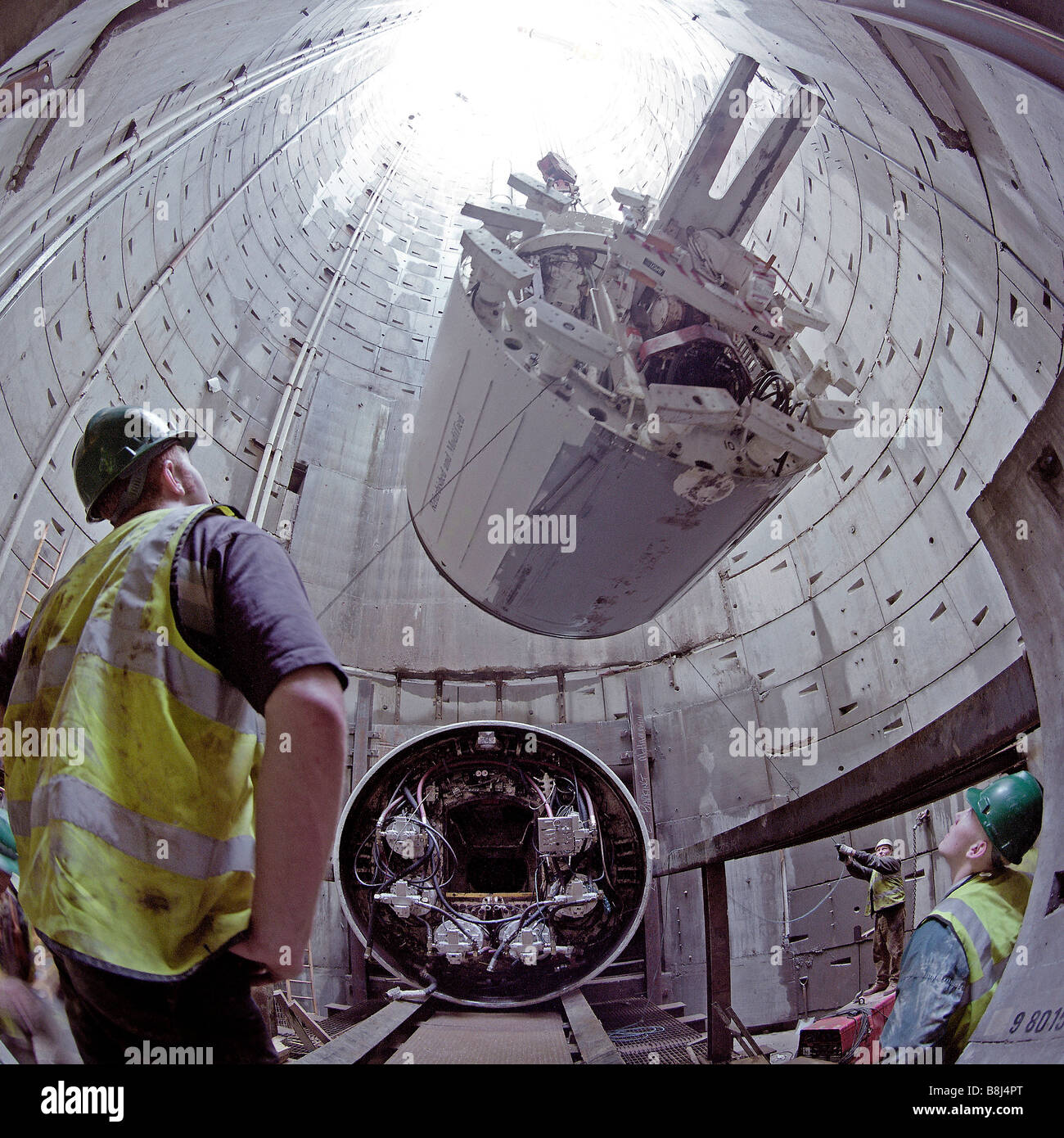 Contractors lowering tunnel boring machine, which will excavate power ...