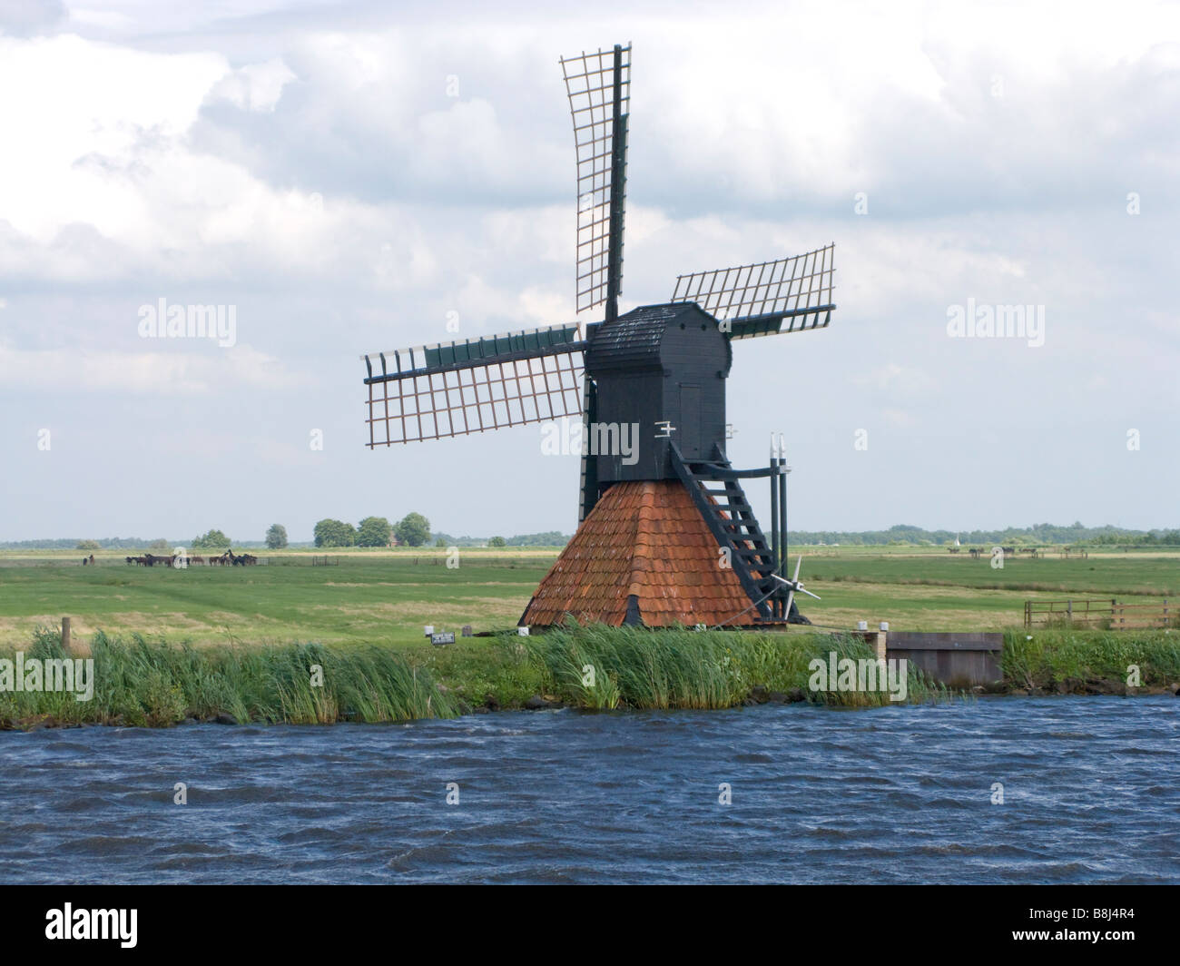 Old Windmill in Princess Margaret Canal, Friesland Stock Photo - Alamy