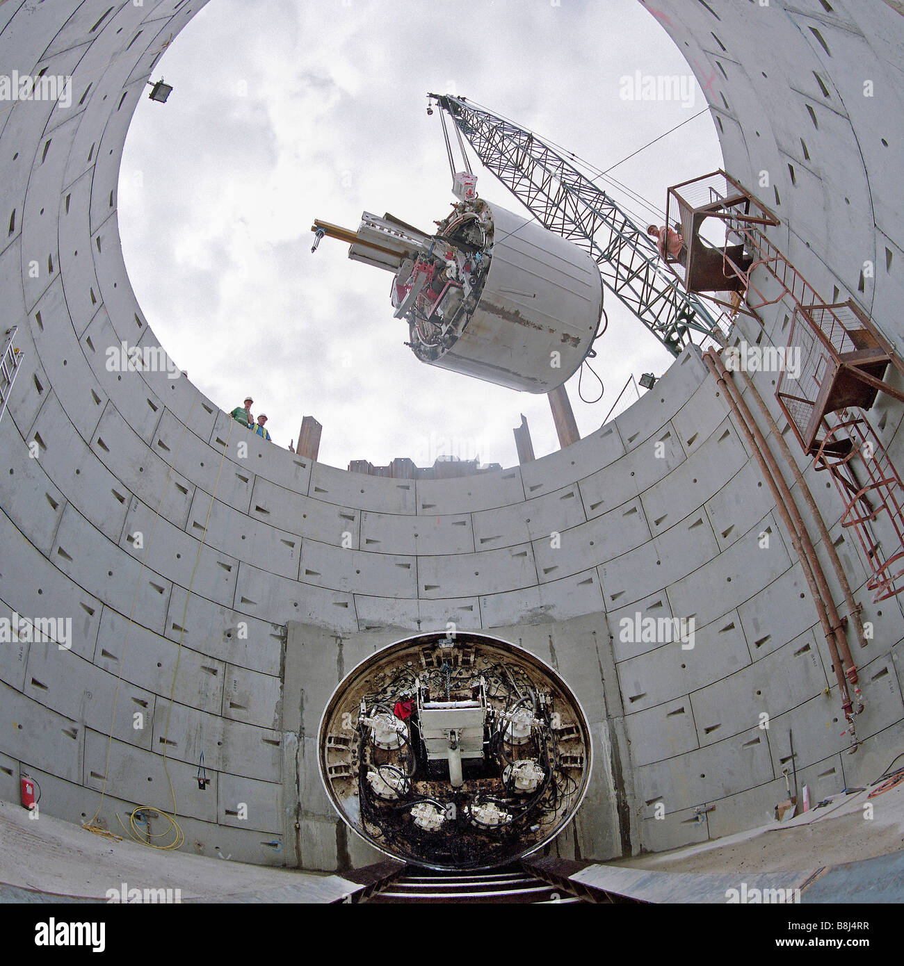 Contractors lowering tunnel boring machine, which will excavate power ...