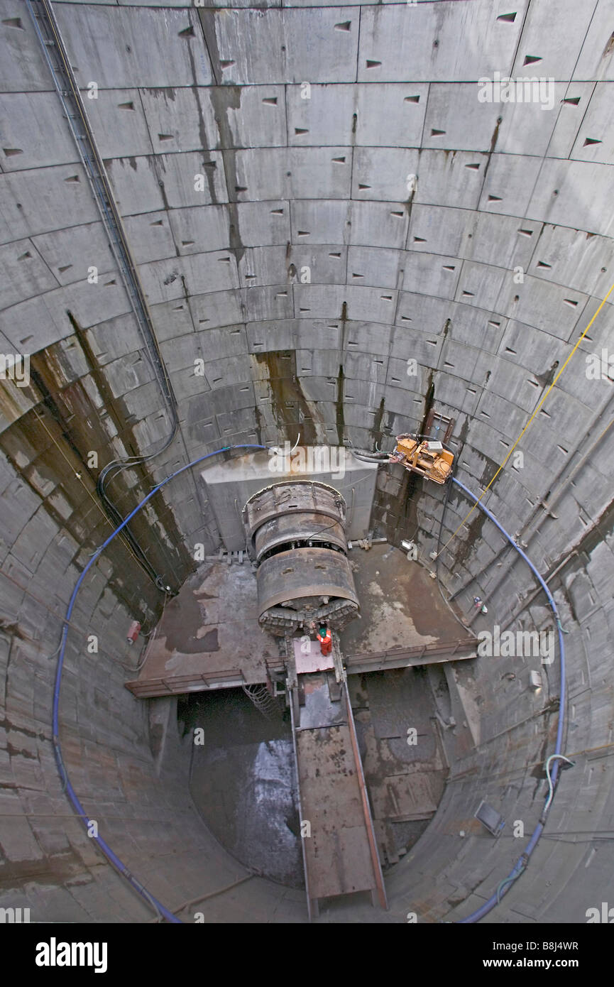 Engineer inspecting tunnel boring machine which has completed ...