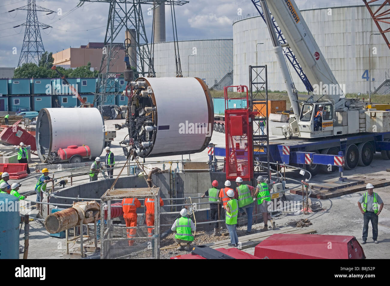 Contractors lowering a tunnel boring machine into an access shaft, the ...