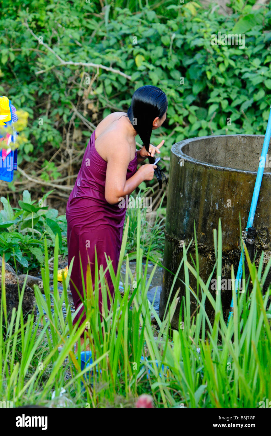 Karen lady having shower from cement sinkhole,Tak,Northern Thailand ...
