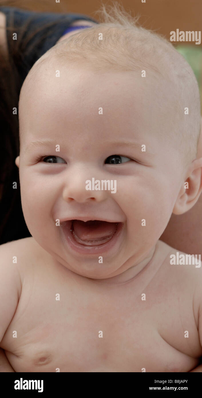 A baby boy with blue eyes smiles and chuckles Stock Photo - Alamy