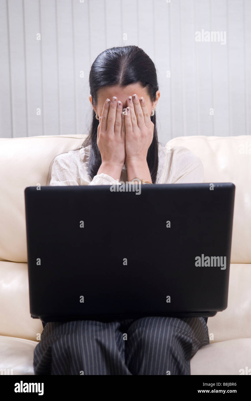 Woman with laptop computer crying Stock Photo - Alamy