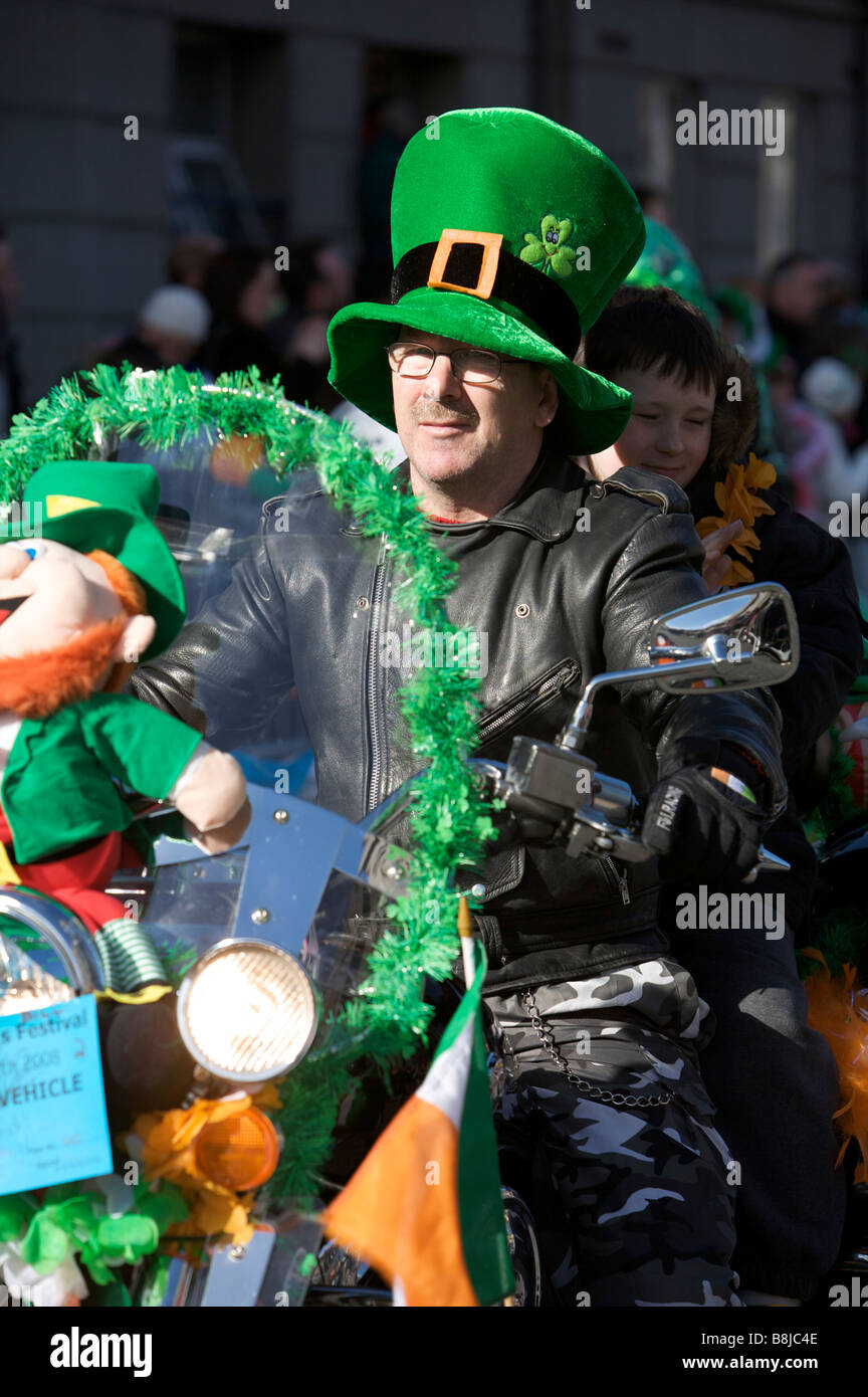 A biker participant rides past the crowd in the St Patricks Day Parade ...