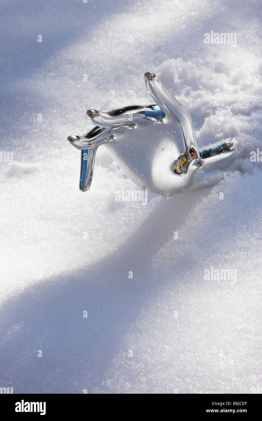 Metallic chrome hand reaching out from beneath snow Stock Photo - Alamy