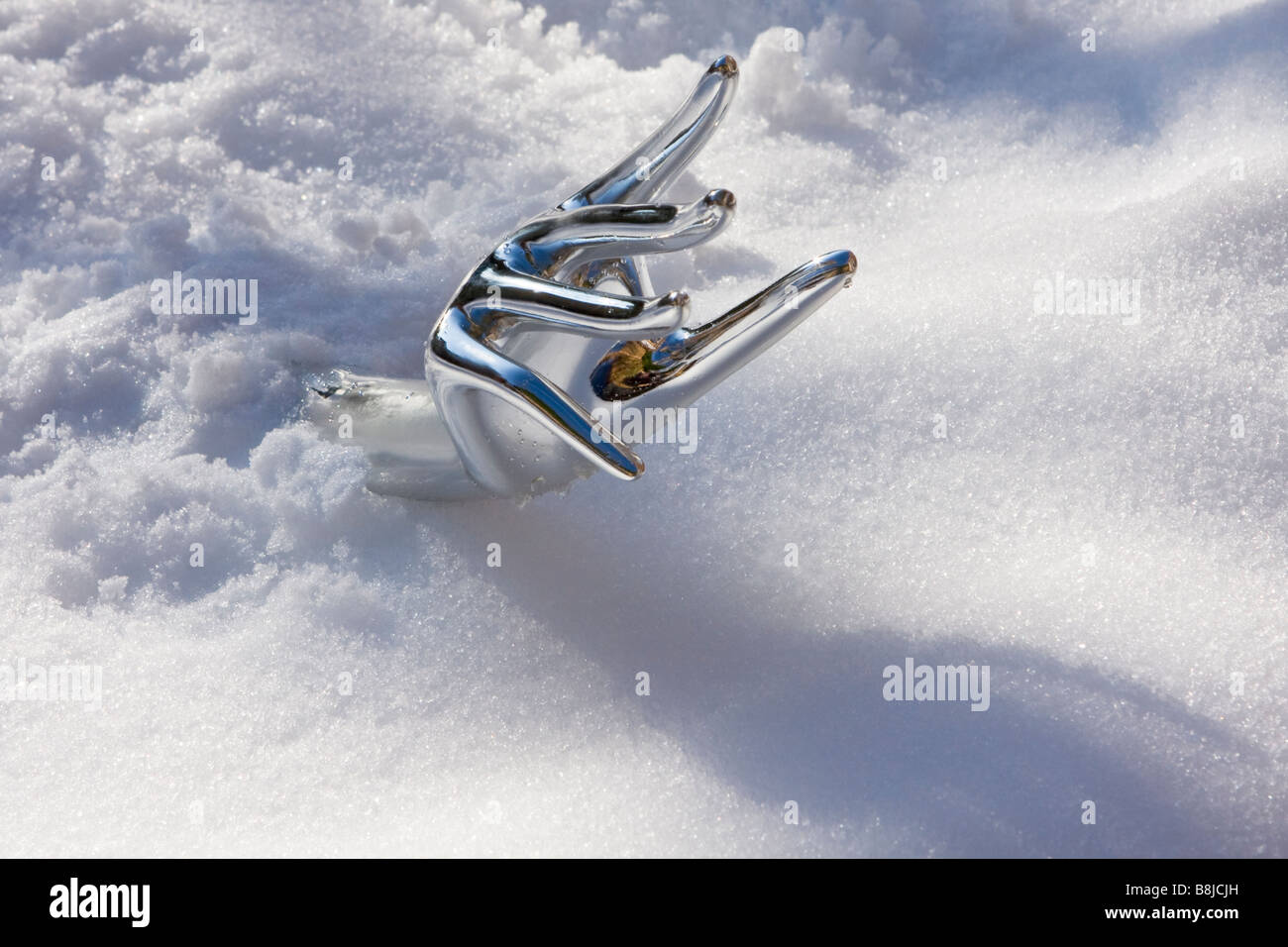 Metallic chrome hand reaching out from beneath snow Stock Photo - Alamy