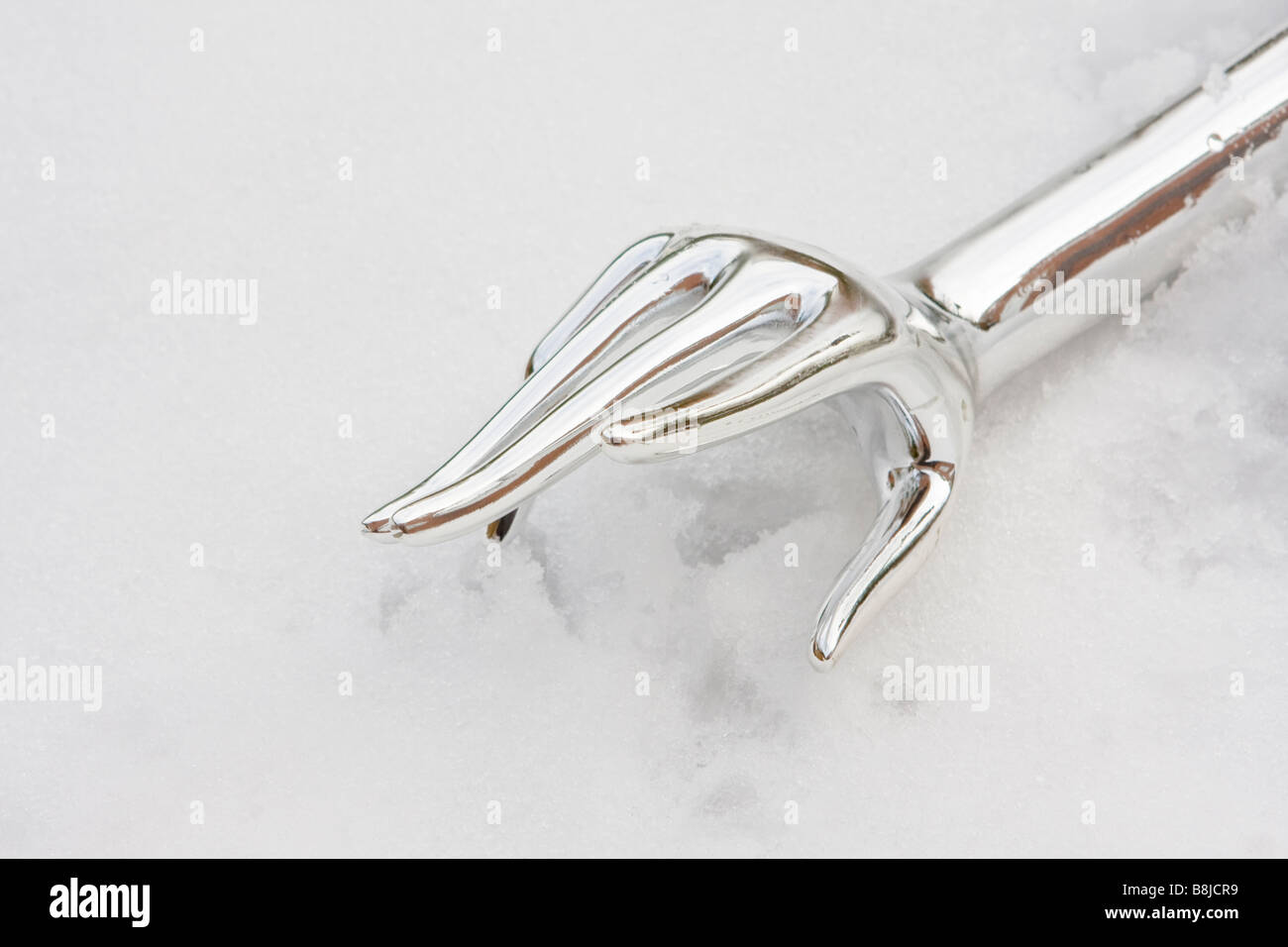 Metallic chrome hand reaching out from beneath snow Stock Photo - Alamy