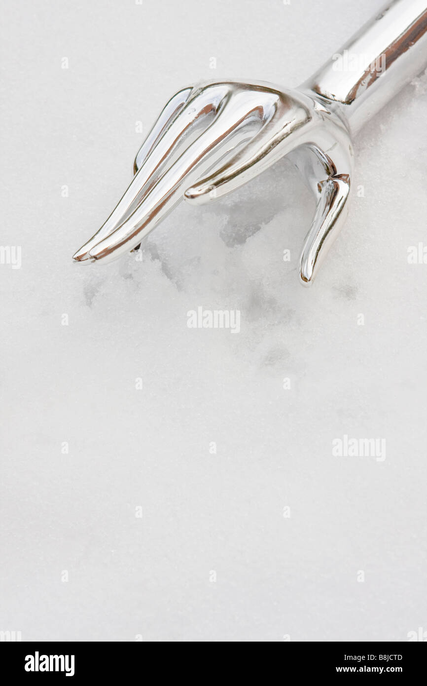 Metallic chrome hand reaching out from beneath snow Stock Photo - Alamy